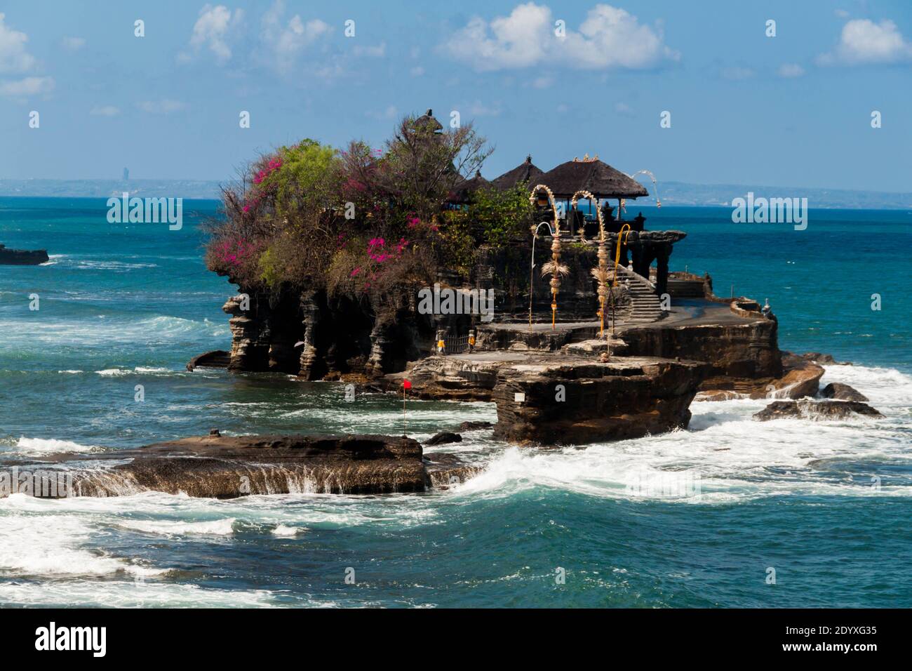 Tanah Lot Temple, one of the most famous landmarks of Bali, in the wavy ...
