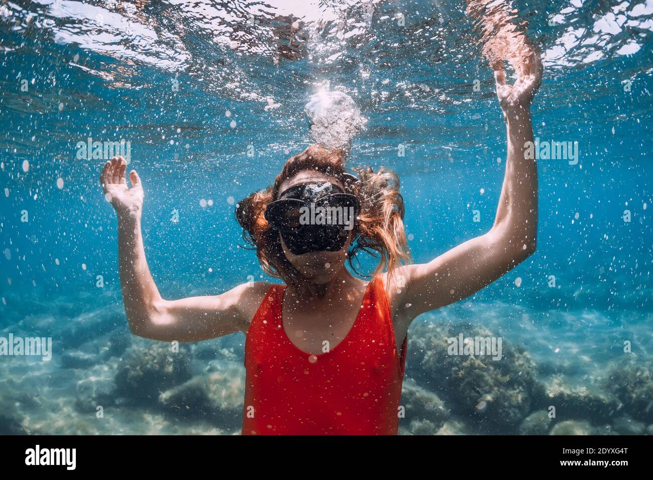 Young woman with freediving mask posing underwater in blue ocean Stock ...