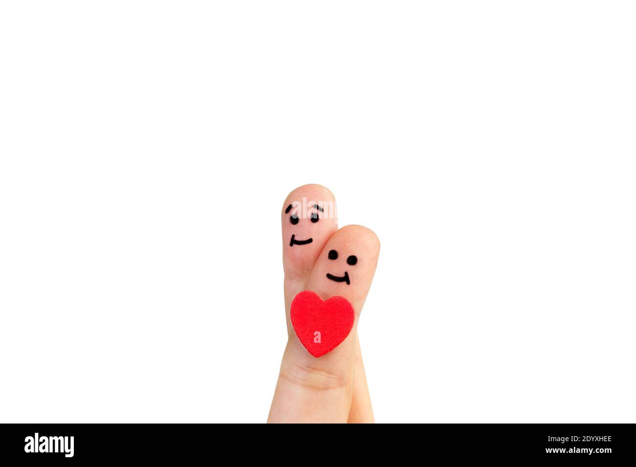 Crossed fingers with happy face and a red heart on a white background ...