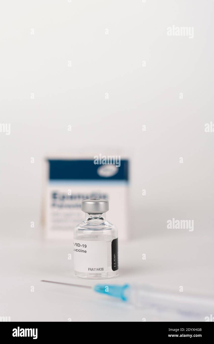 Covid-19 vaccine vial, syringe with needle and paper box with vials ...