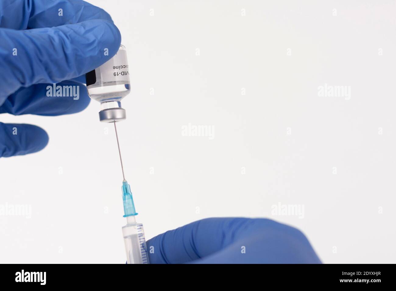 Close up human fingers in gloves, holding covid-19 vaccine vial and ...