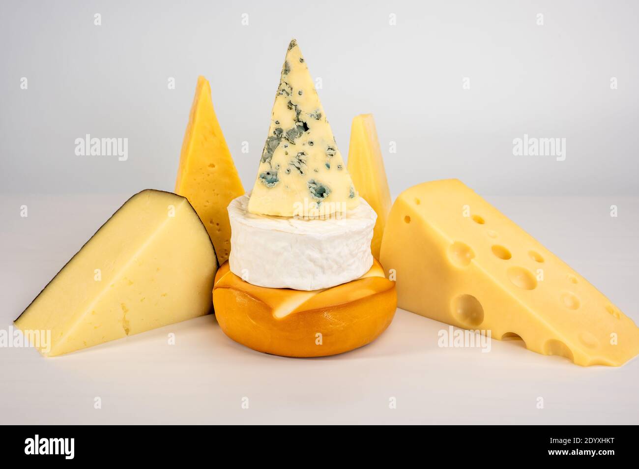 Different types of delicious cheese on grey background. blue cheese ...