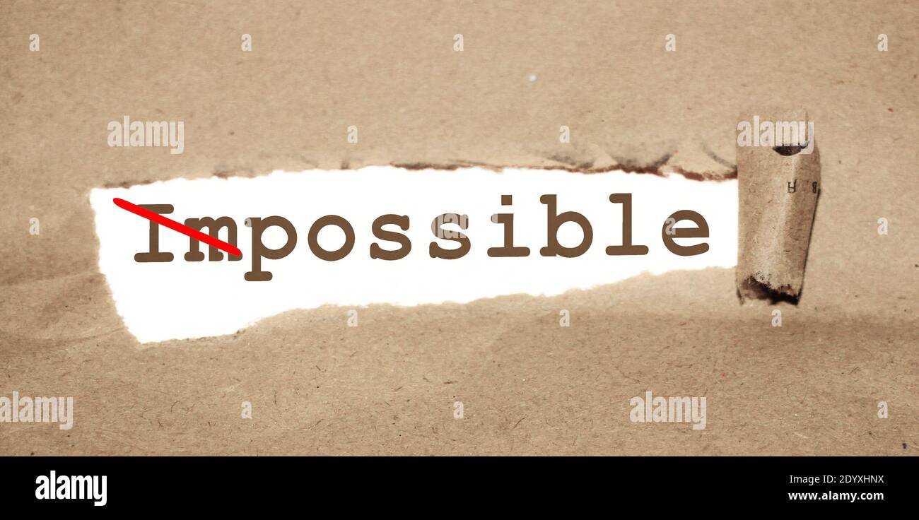 torn paper with IMPOSSIBLE word turned to Possible by crossing IM ...