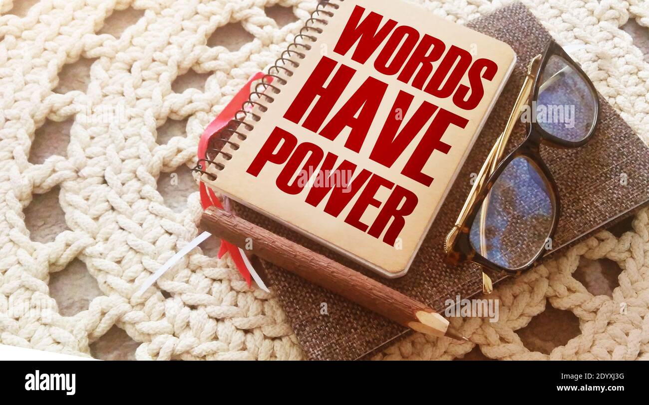 Words have power text on the cover of notebook, glasses and pen on ...