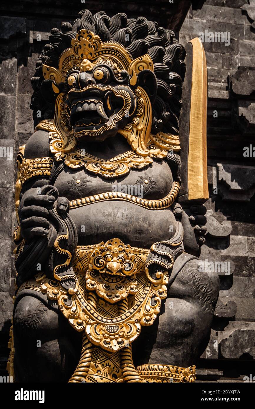 A vertical image of the giant Dvarapala (gate guardian) at Tanah Lot ...