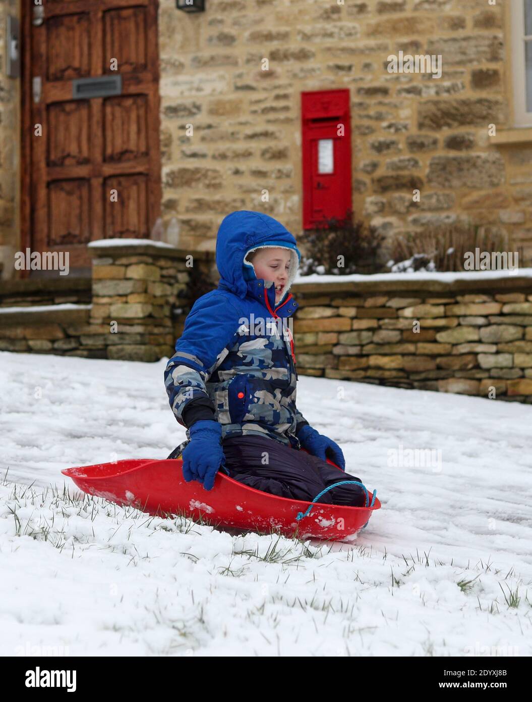 Konrad (surname not given) sledges in the snow in Burford, West ...