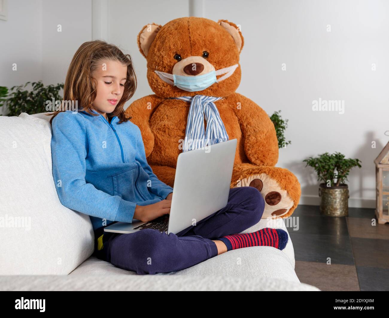 Child studies at home, wear protective masks, and doing school homework ...