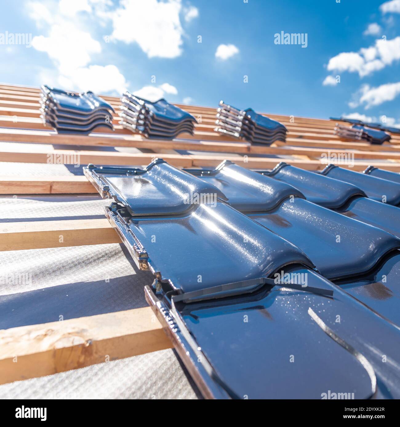 production of roofs from ceramic fired tiles on a family house Stock ...