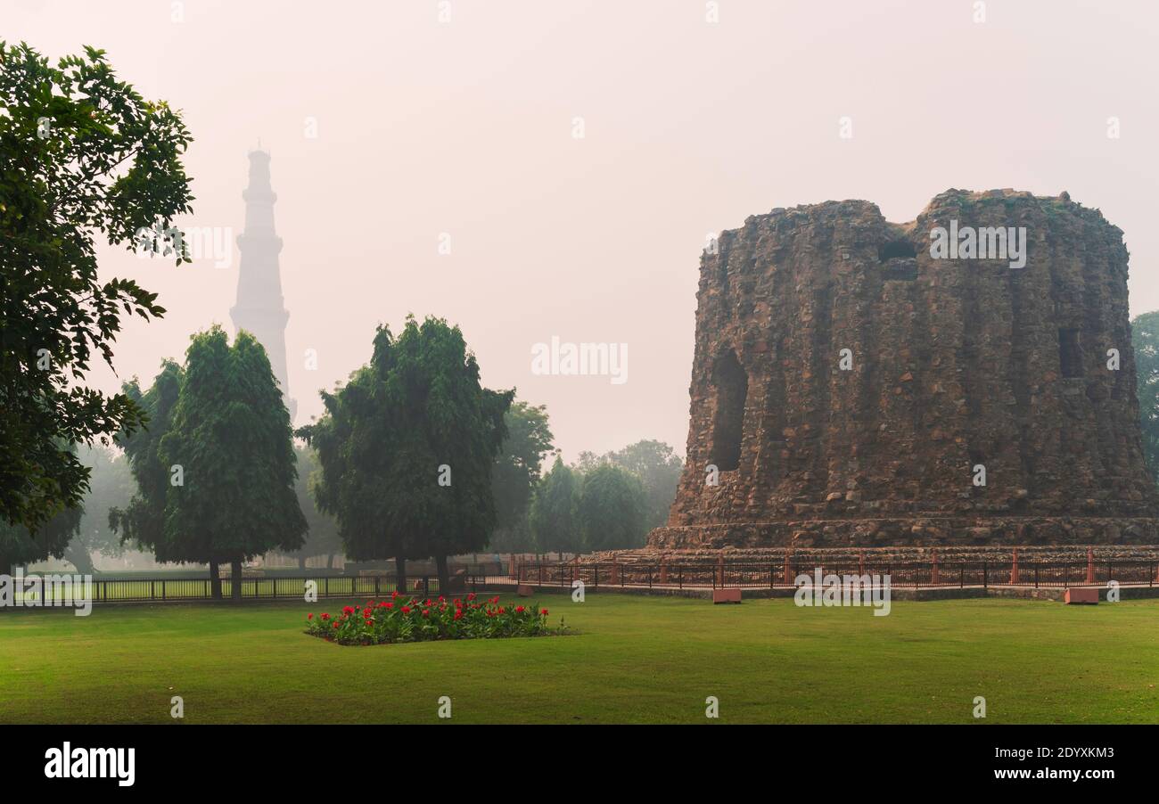 Inside the Qutb Minar complex with ancient ruins and view of the tall ...