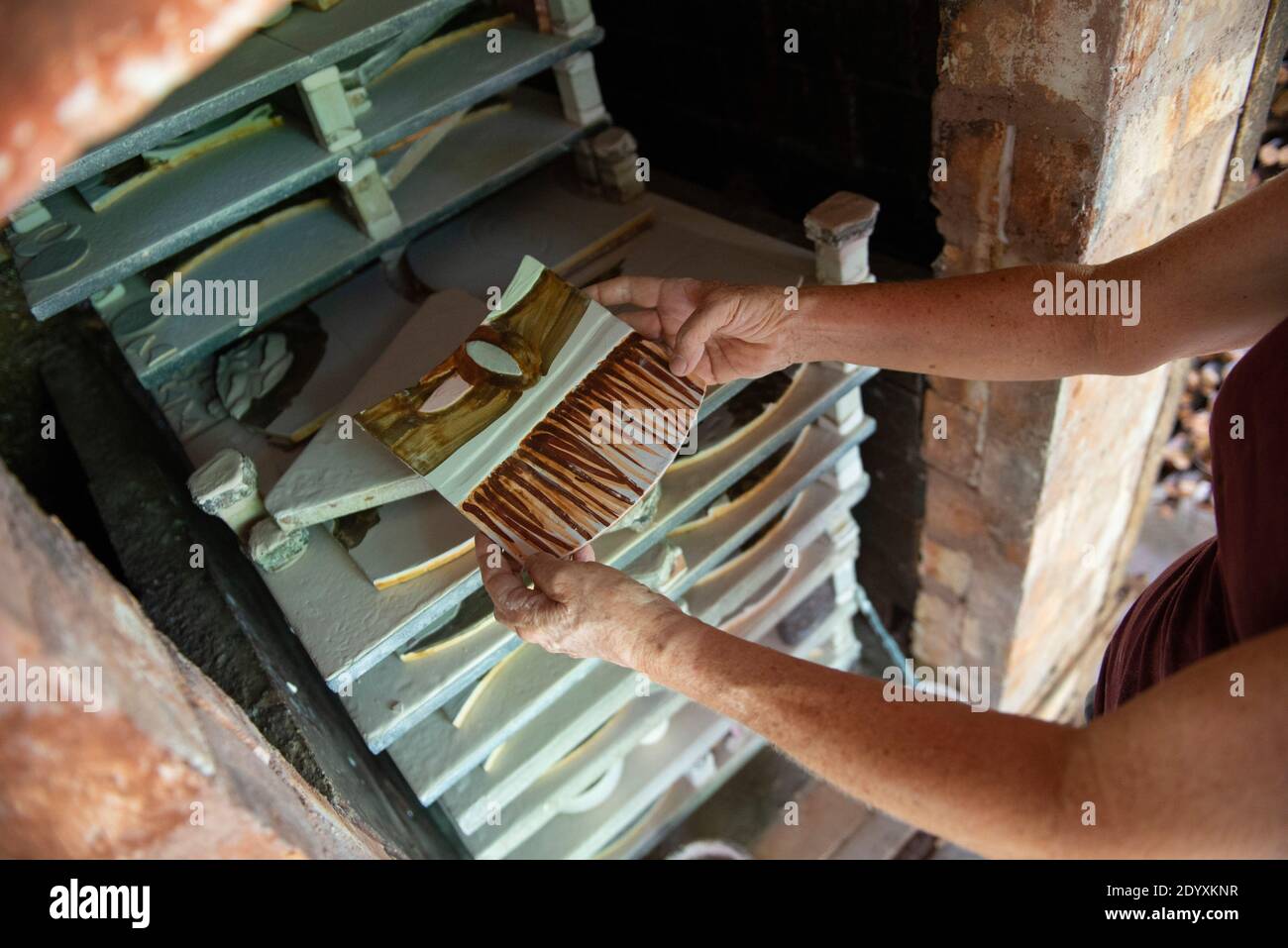 TAMIL NADU, INDIA - June 2020: Potter at work. Loading tiles before ...