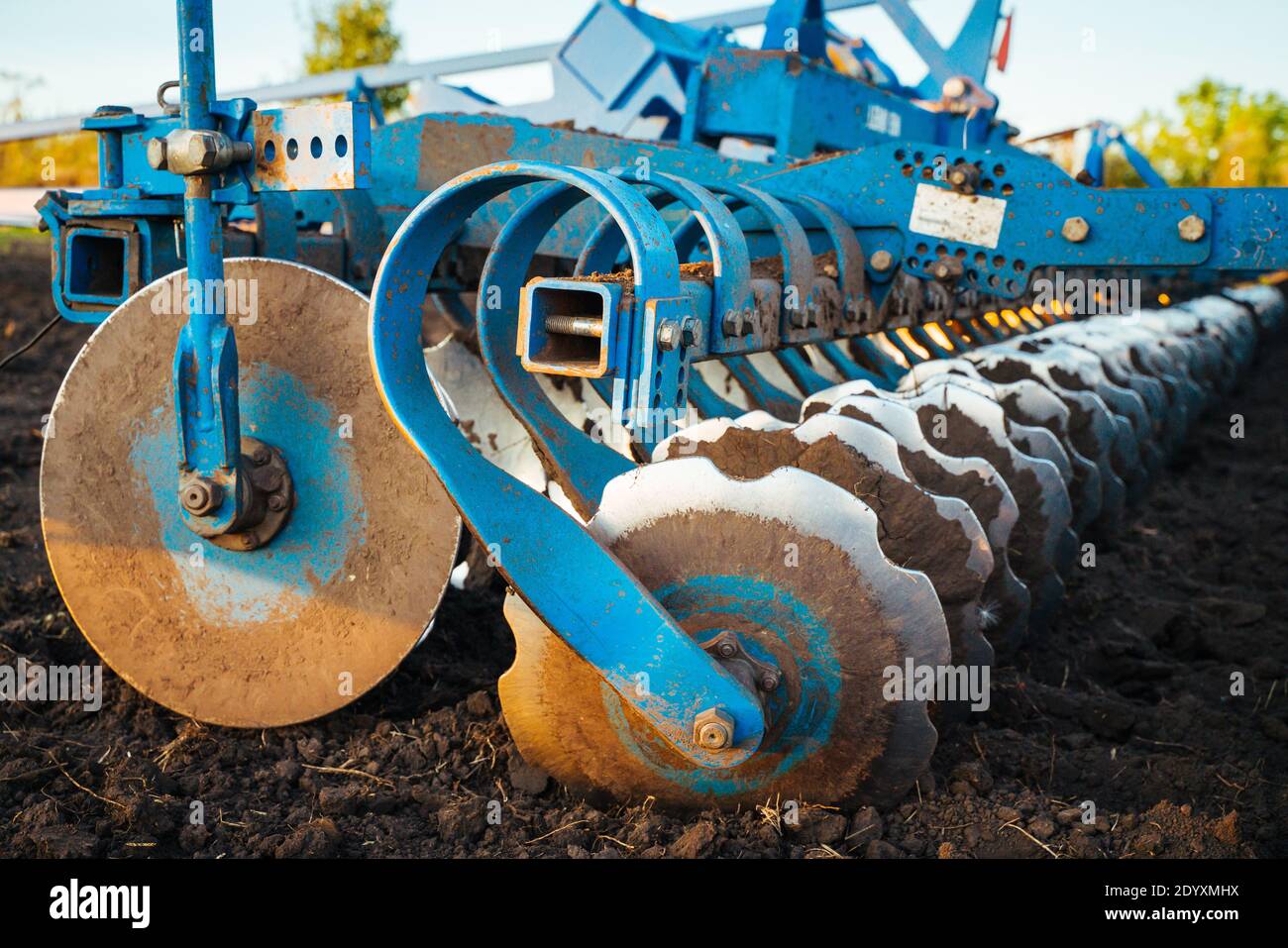 The tractor plows the land. Agricultural machinery, plow Stock Photo ...