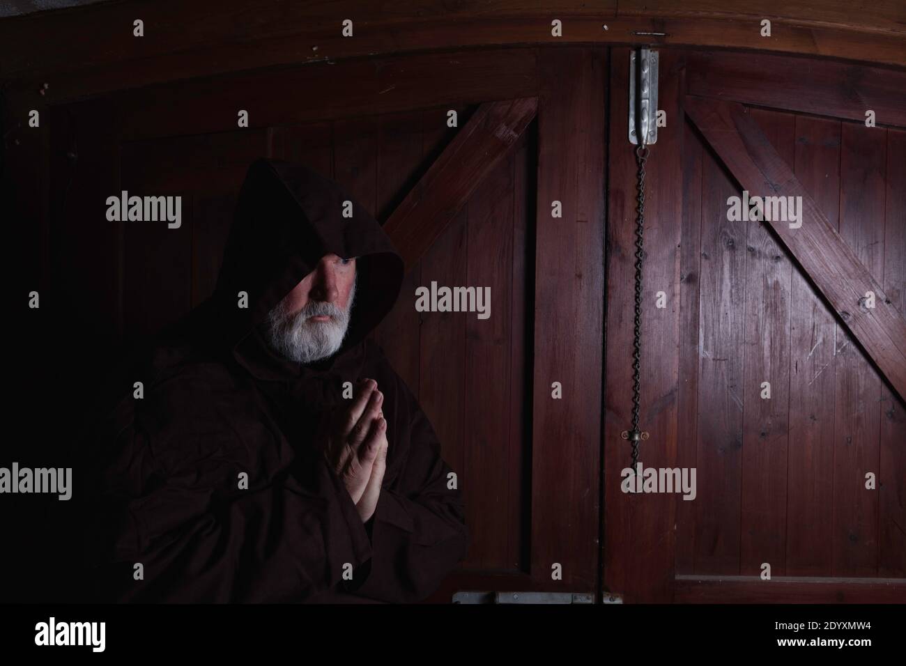 Portrait of an elderly Franciscan monk praying Stock Photo - Alamy