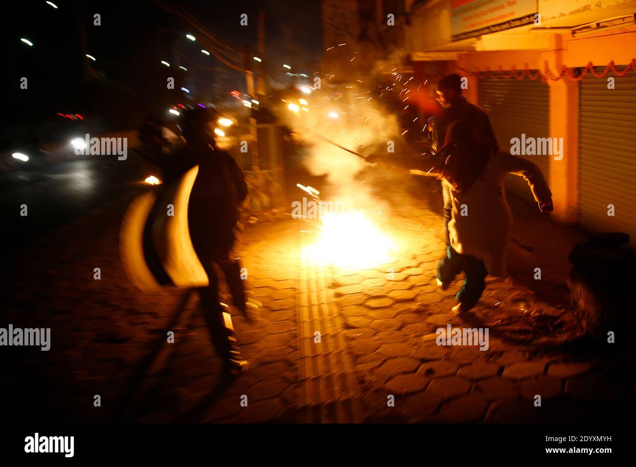 Kathmandu, Nepal. 28th Dec, 2020. Riot Police personnel douse torches ...