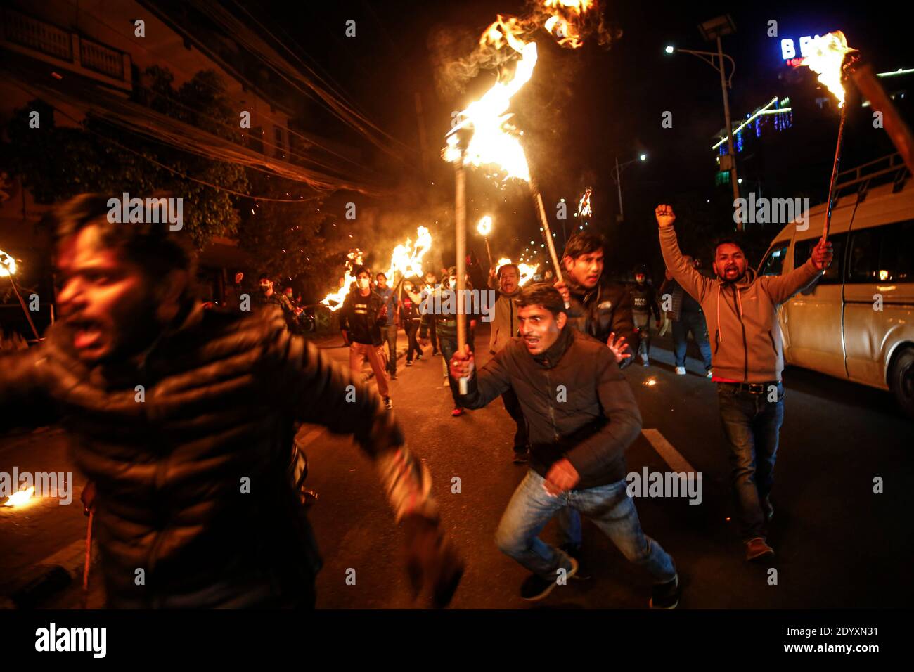 Kathmandu, Nepal. 28th Dec, 2020. Riot Police personnel douse torches ...