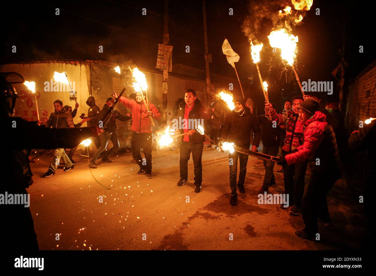 Kathmandu, Nepal. 28th Dec, 2020. Riot Police personnel douse torches ...
