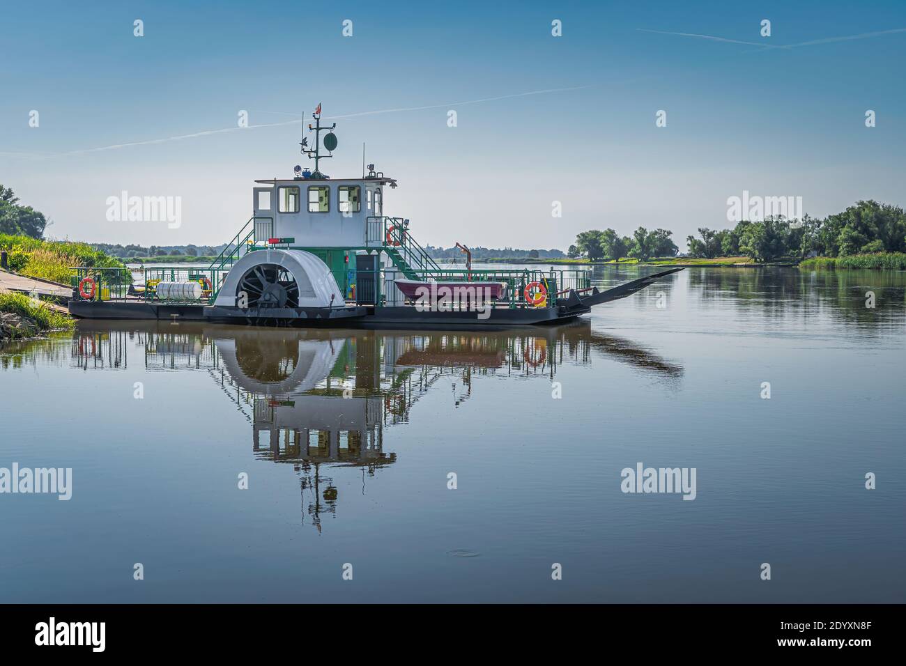Small, vintage paddle steamer ferry operating on Oder River crossing ...