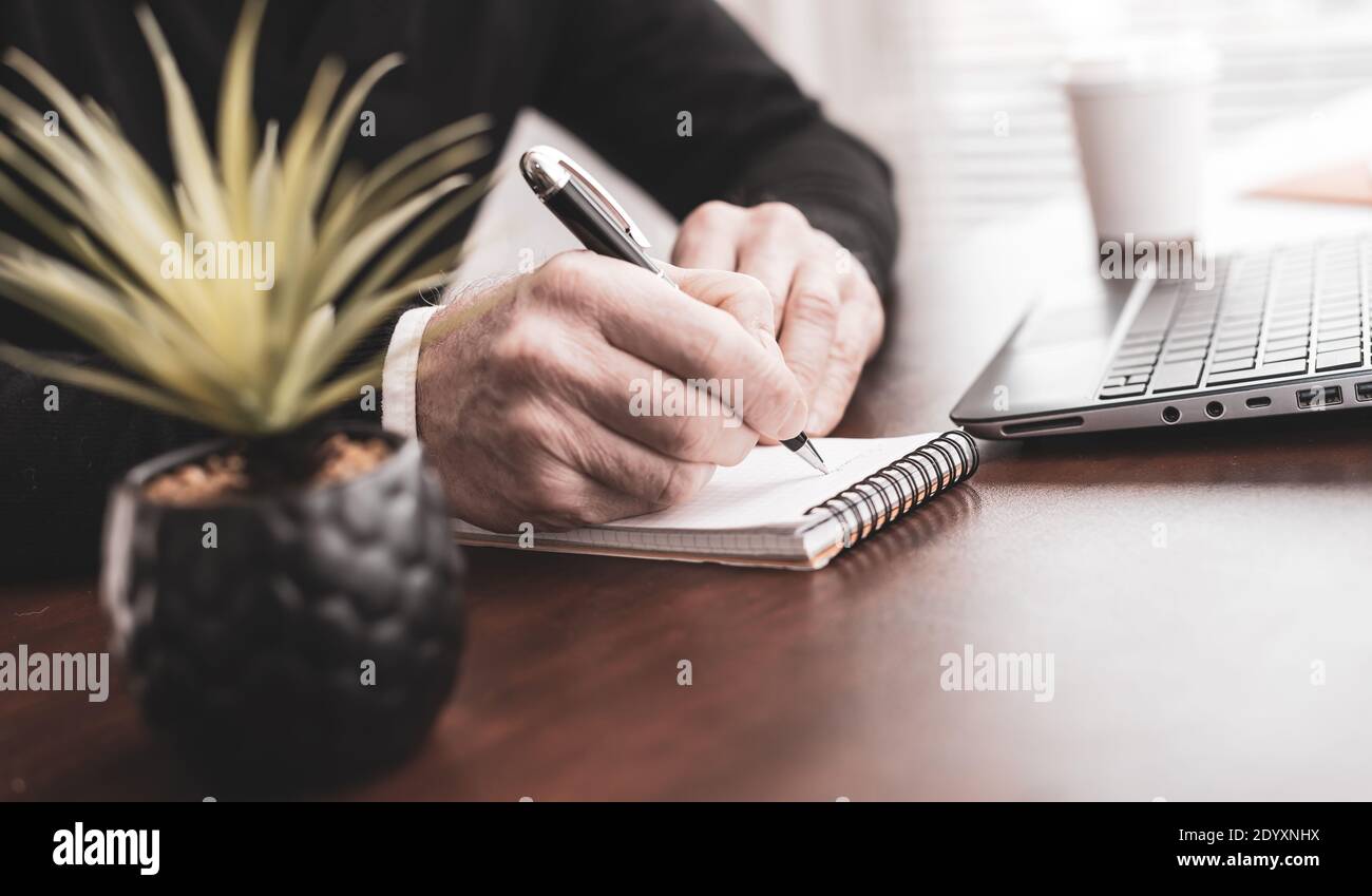 Male hands taking notes on notebook Stock Photo - Alamy