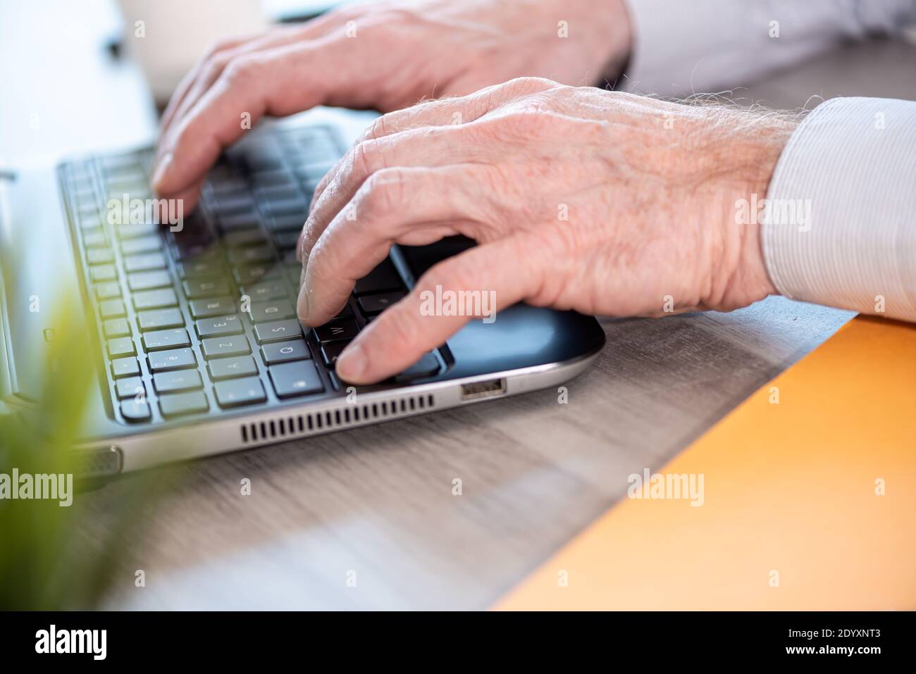 Male hands typing on laptop keyboard Stock Photo - Alamy