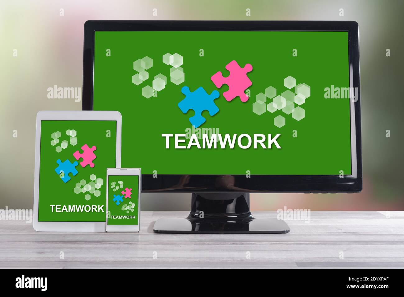 Teamwork concept shown on different information technology devices ...