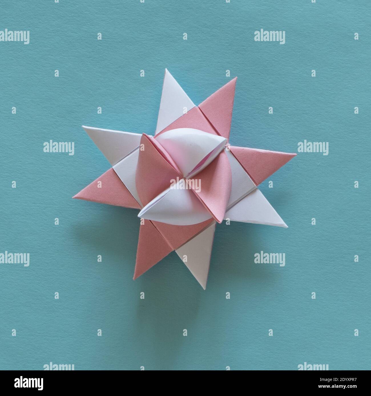 Top view of multicolor origami of 3D stars on a blue background Stock ...