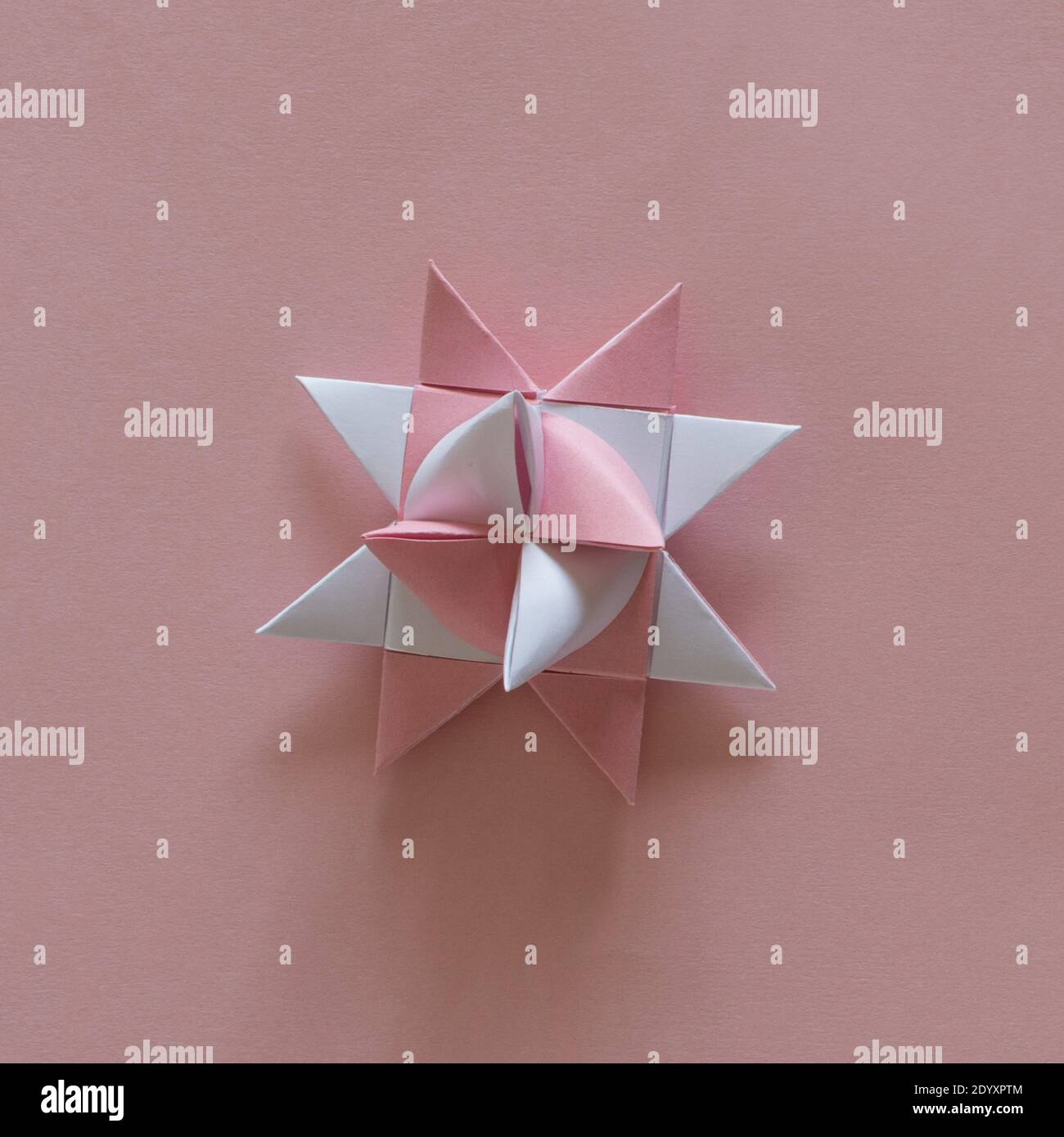Top view of multicolor origami of 3D stars on a pink background Stock ...