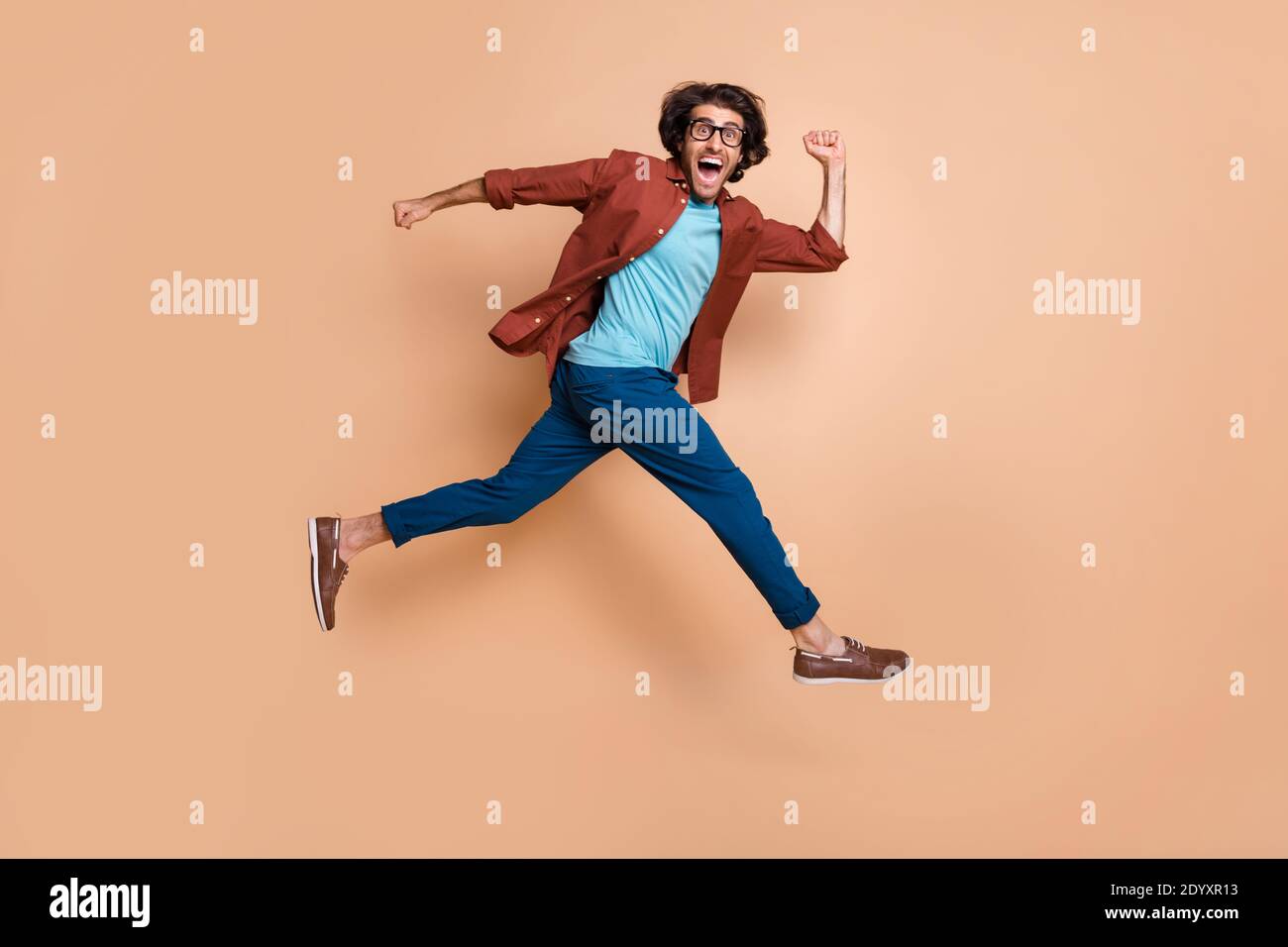 Photo portrait full body view of laughing running guy jumping up ...