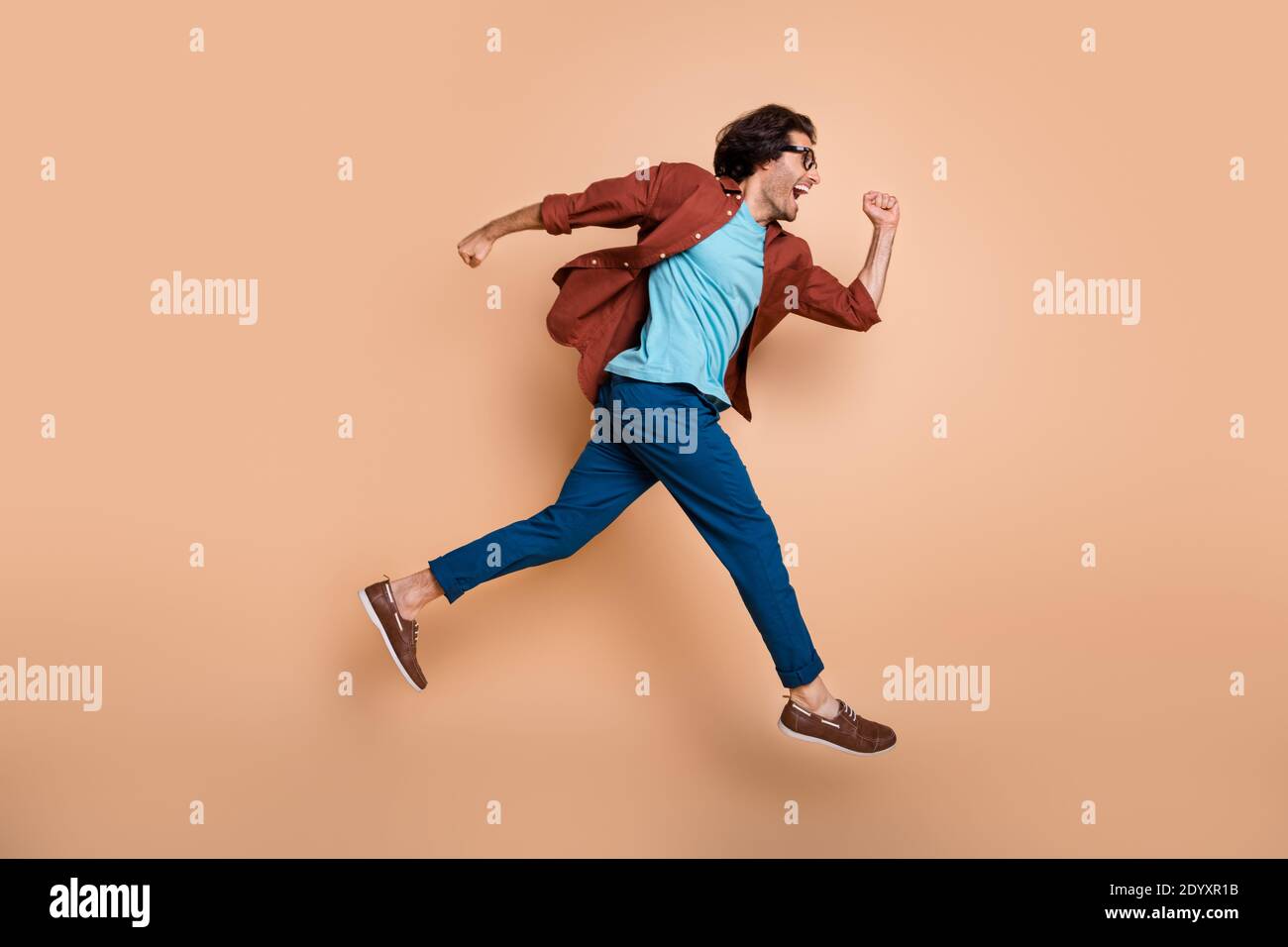 Full length profile photo portrait of man running laughing jumping up ...
