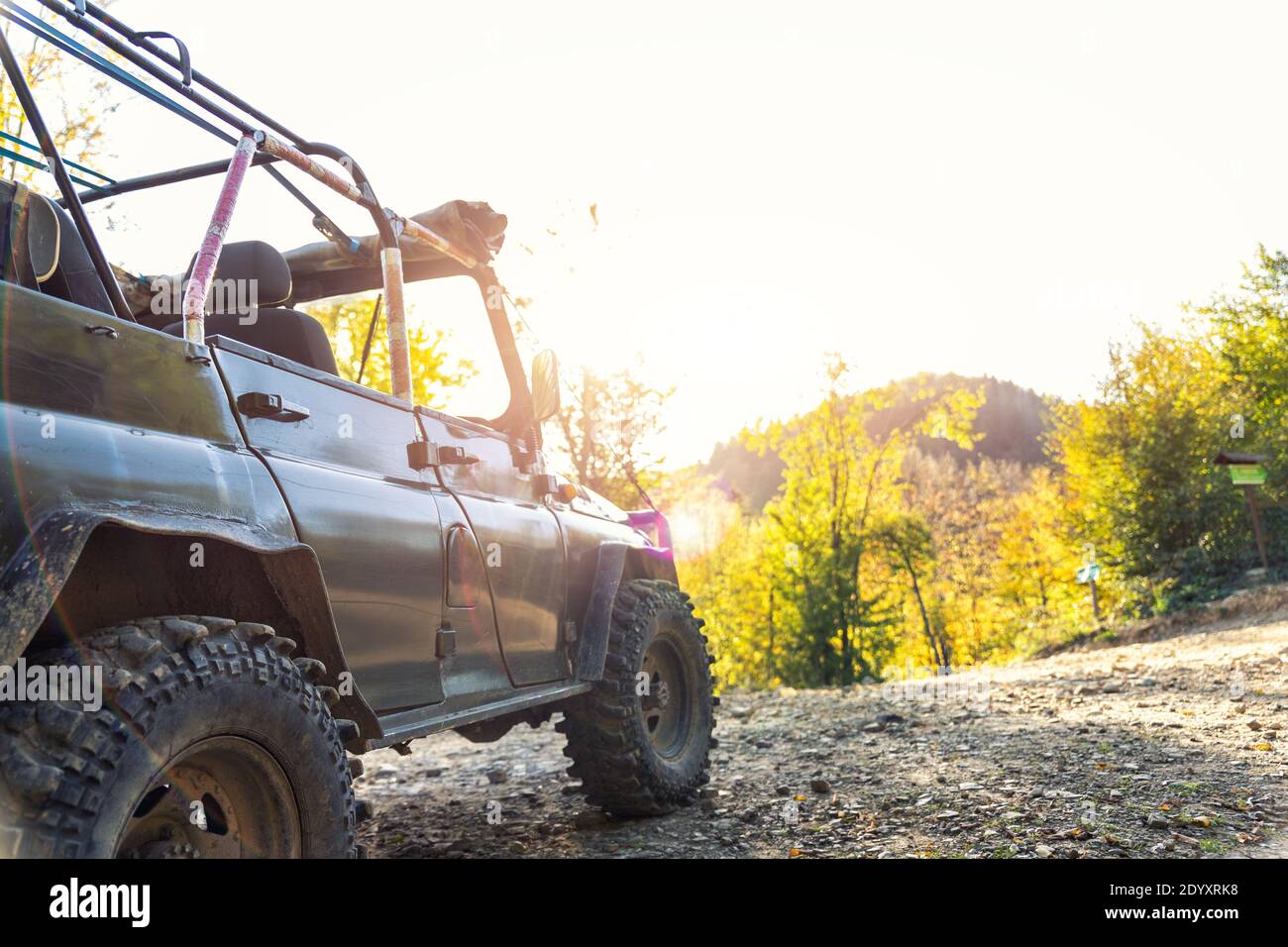 Old retro vintage 4x4 convertible suv vehicle on dirt gravel unpaved ...