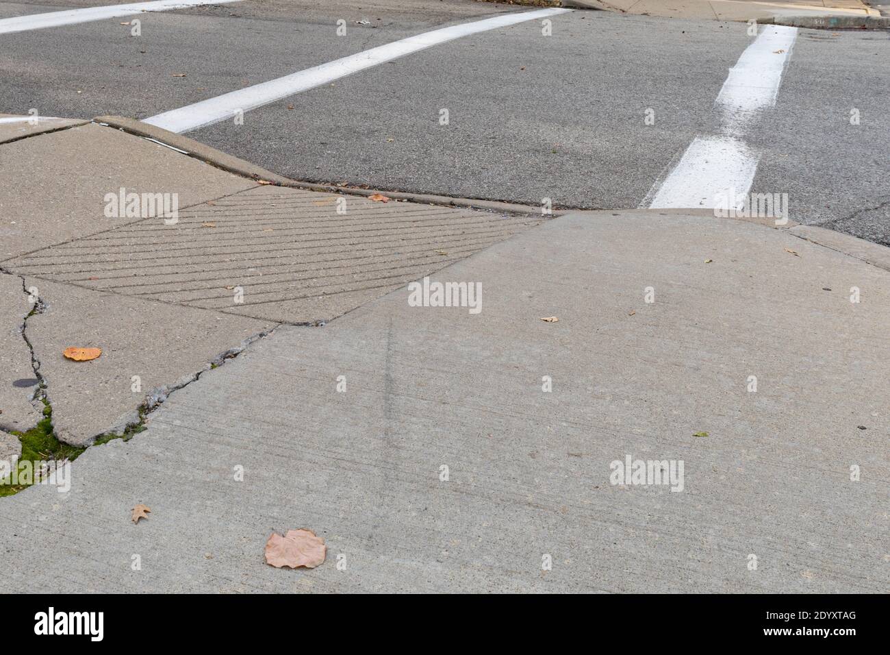 Asphalt street crosswalk and sidewalk with ramp, urban setting ...