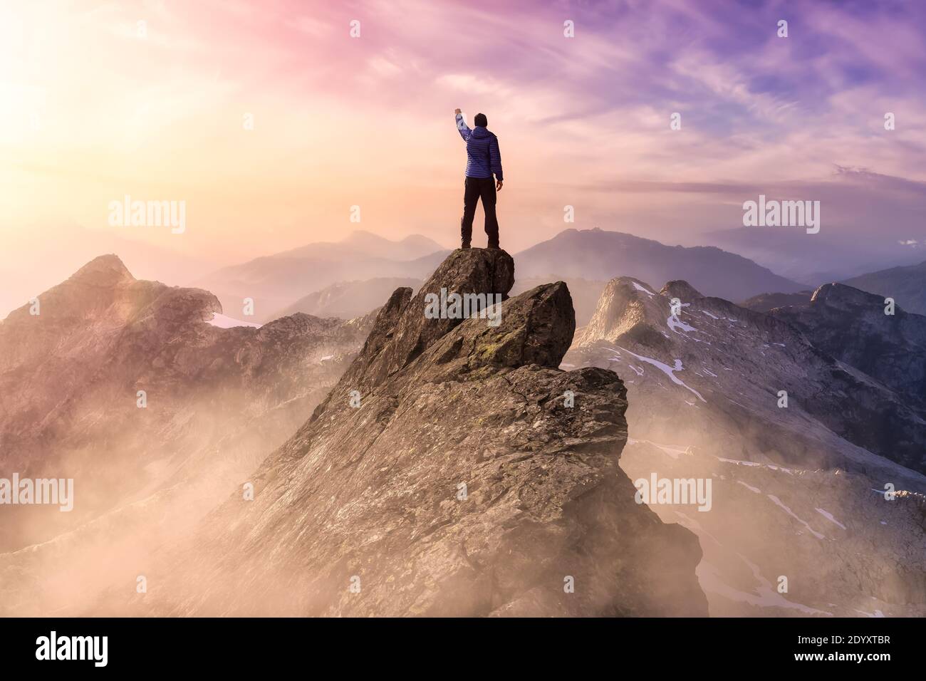 Man on top of a Mountain Cliff Stock Photo - Alamy