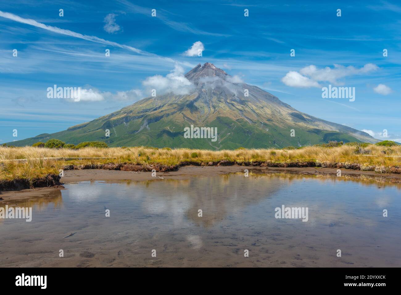 Mt. Taranaki reflected on a pond during a sunny day at New Zealand ...