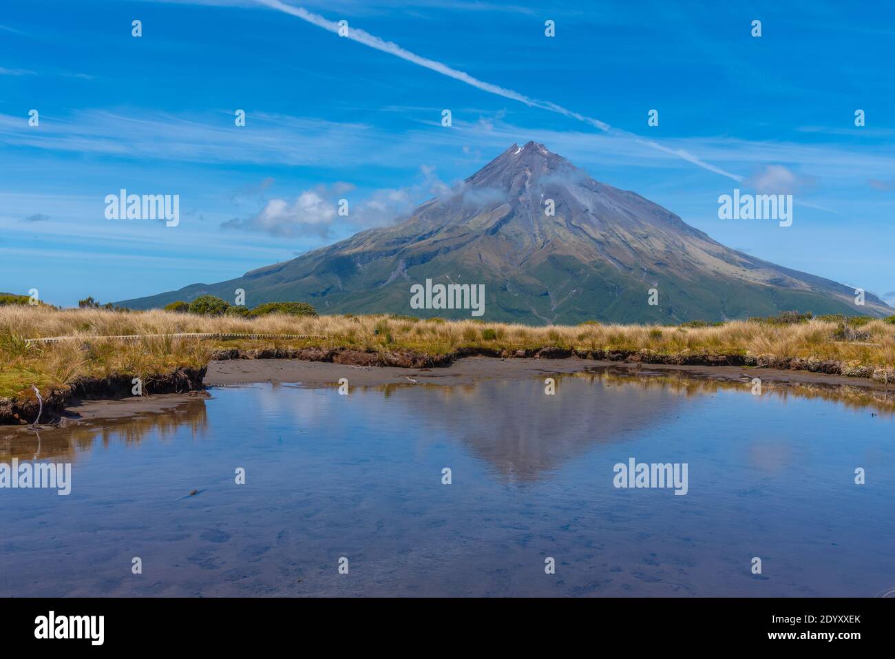 Mt. Taranaki reflected on a pond during a sunny day at New Zealand ...