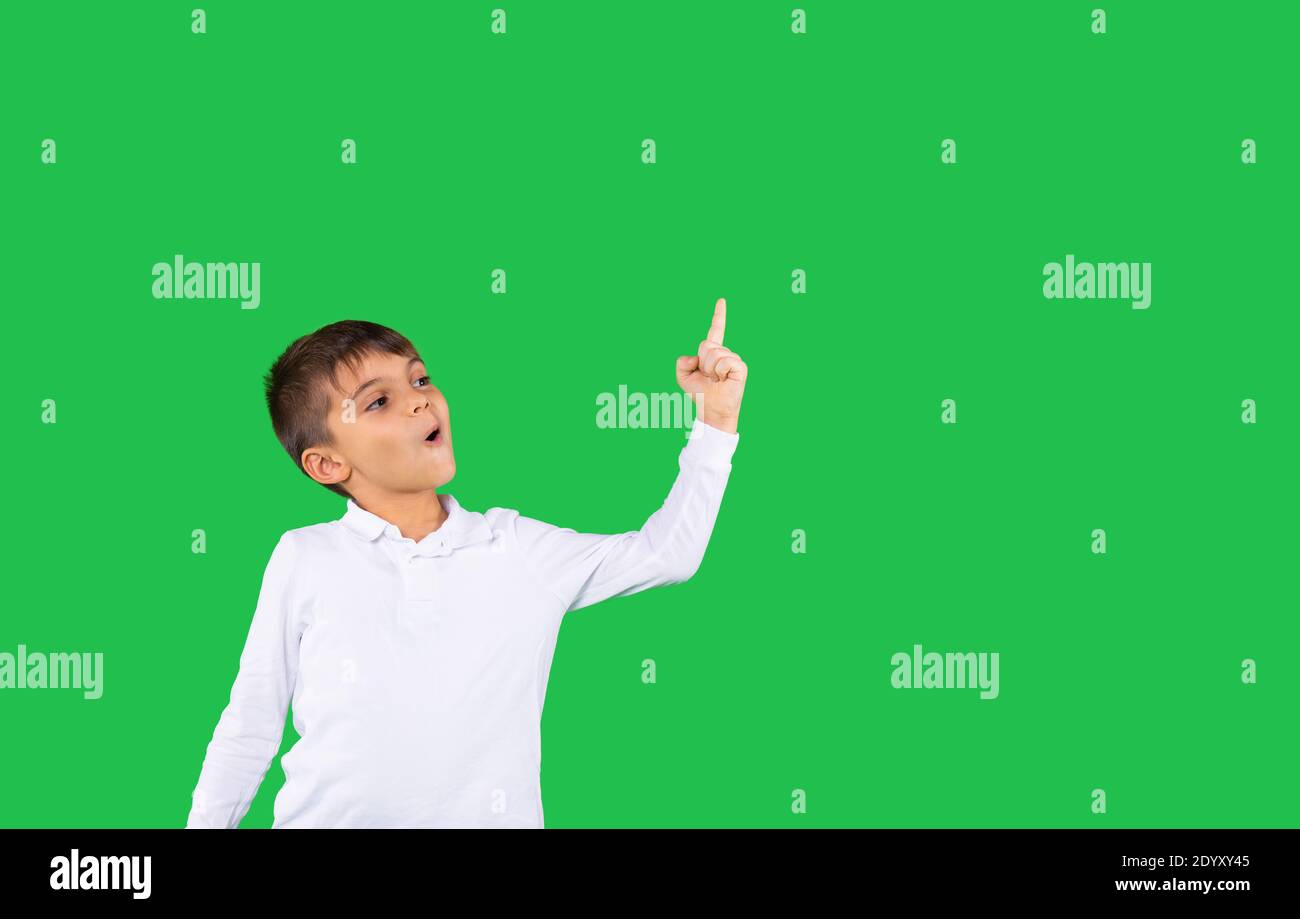 Awesome preschool child is showing index finger, looking up against ...