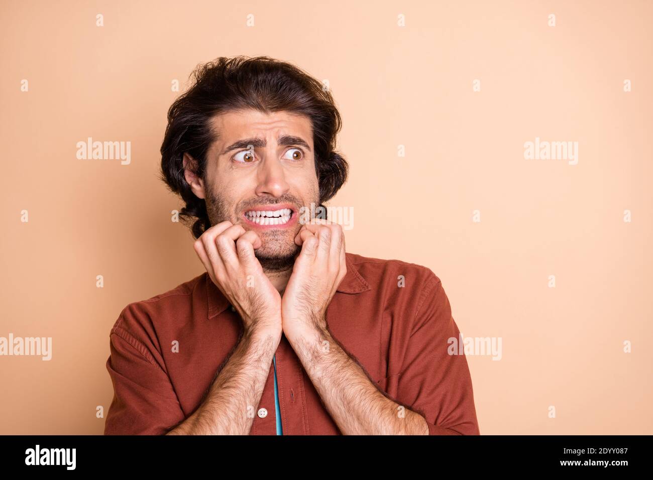 Close-up portrait of nice nervous guy worrying biting nails looking ...