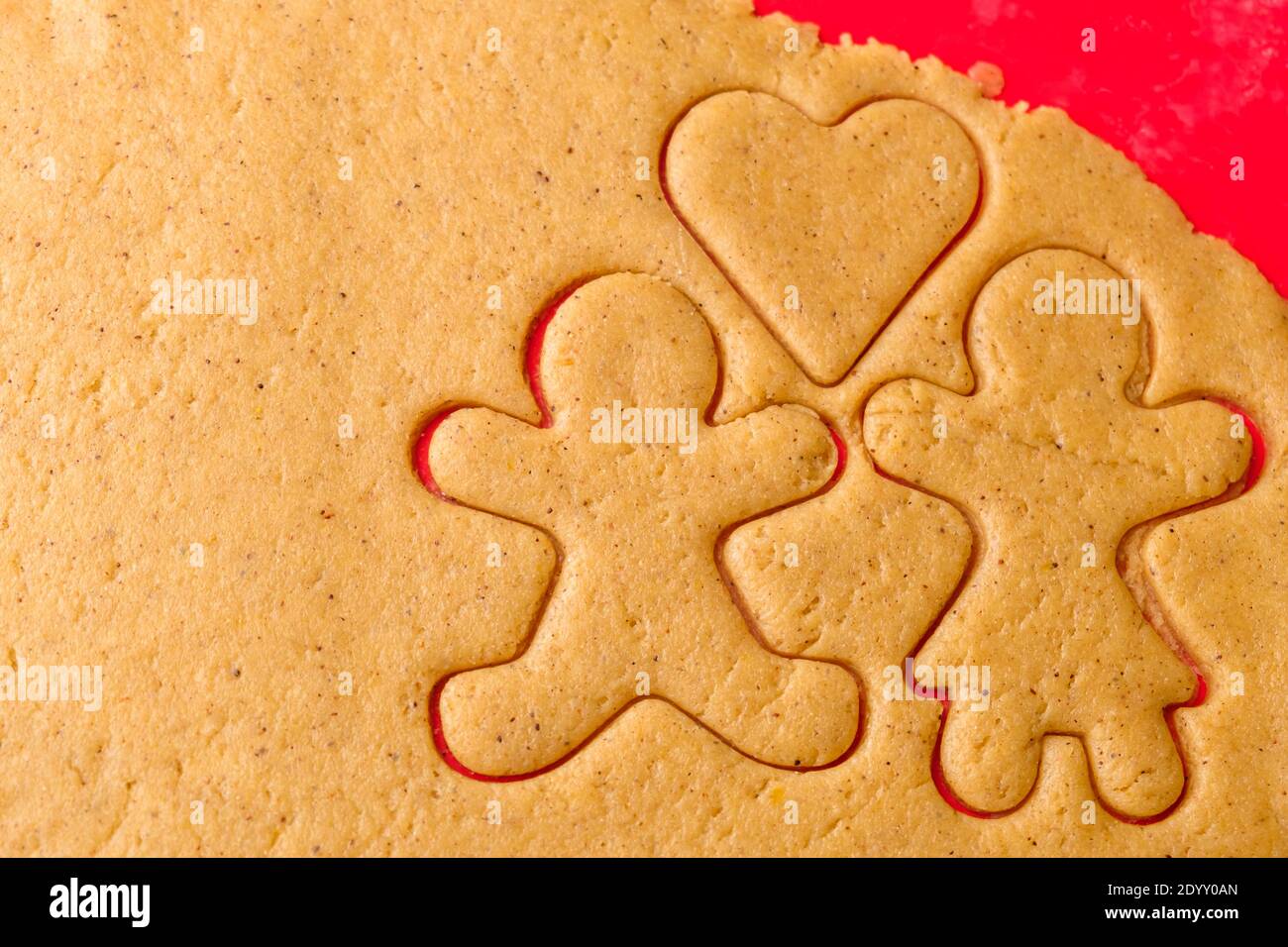 Cutting gingerbread shapes. Family or love couple concept from dough ...