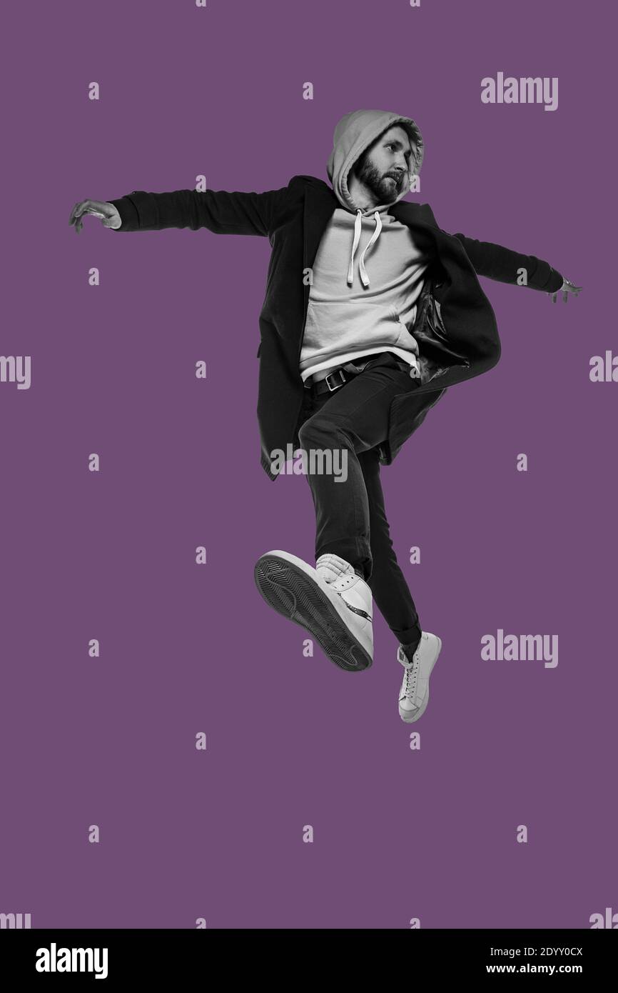 Portrait of young man isolated over purple background. Human emotions ...