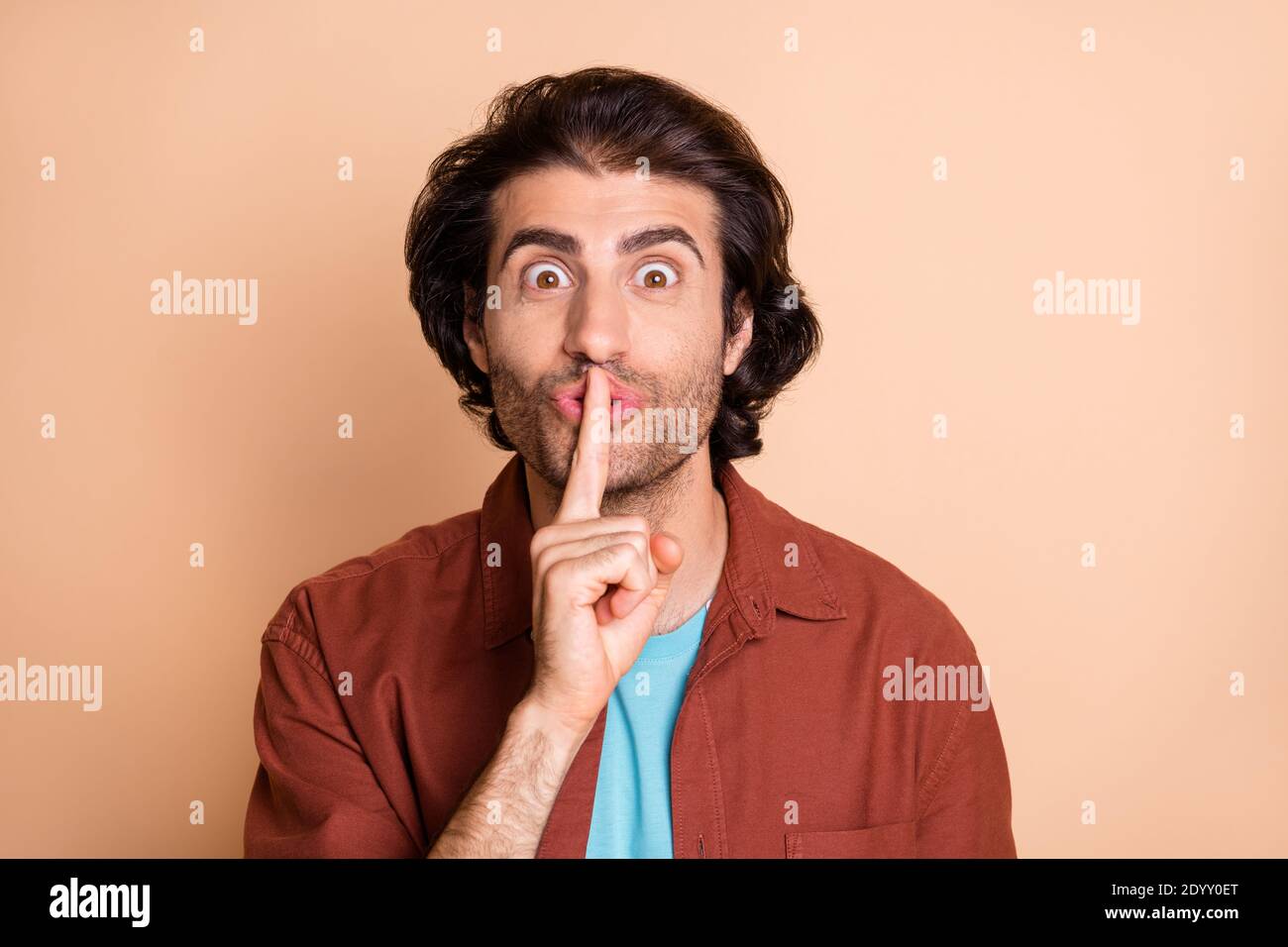 Close-up portrait of nice attractive cheery guy showing showing shh ...