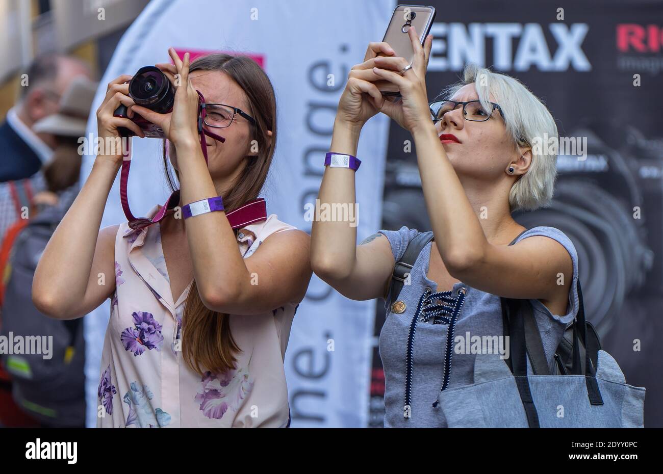 August 18, 2018. Moscow, Russia. Two girls on a busy street are taking ...