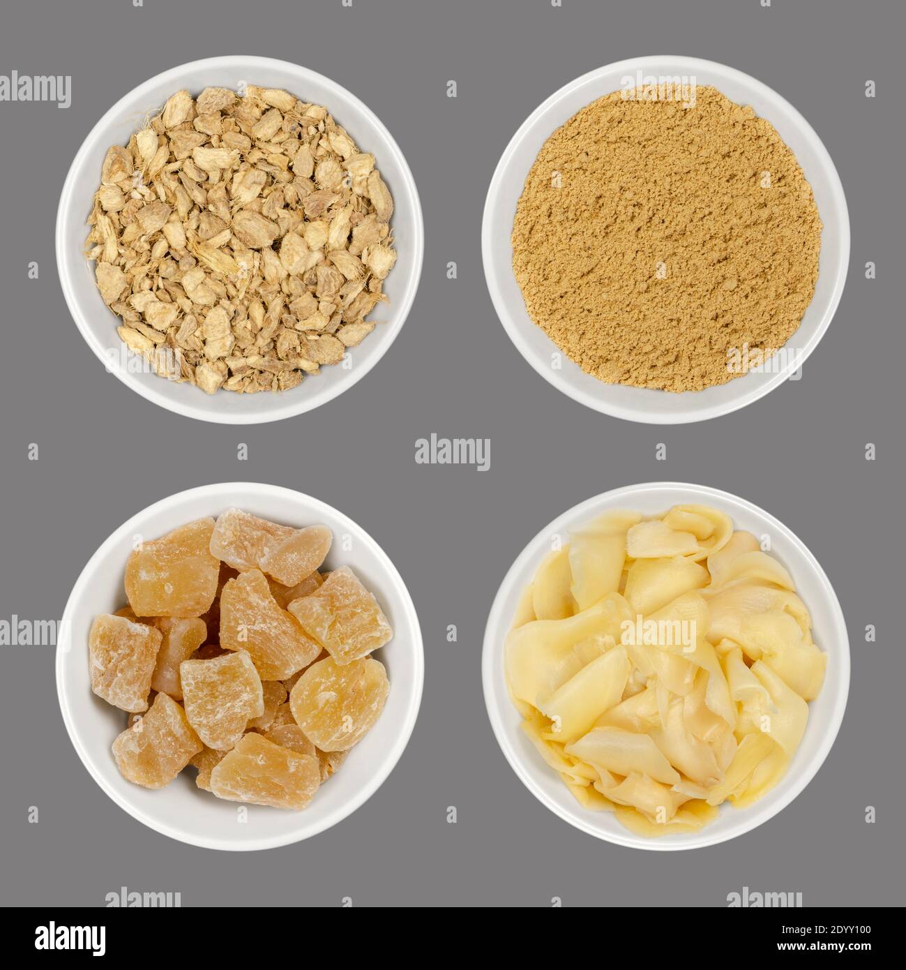 Processed ginger root in white bowls, over gray. Dried and ground ...