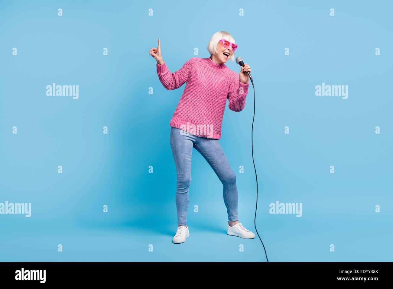 Female singer pointing to microphone hi-res stock photography and ...