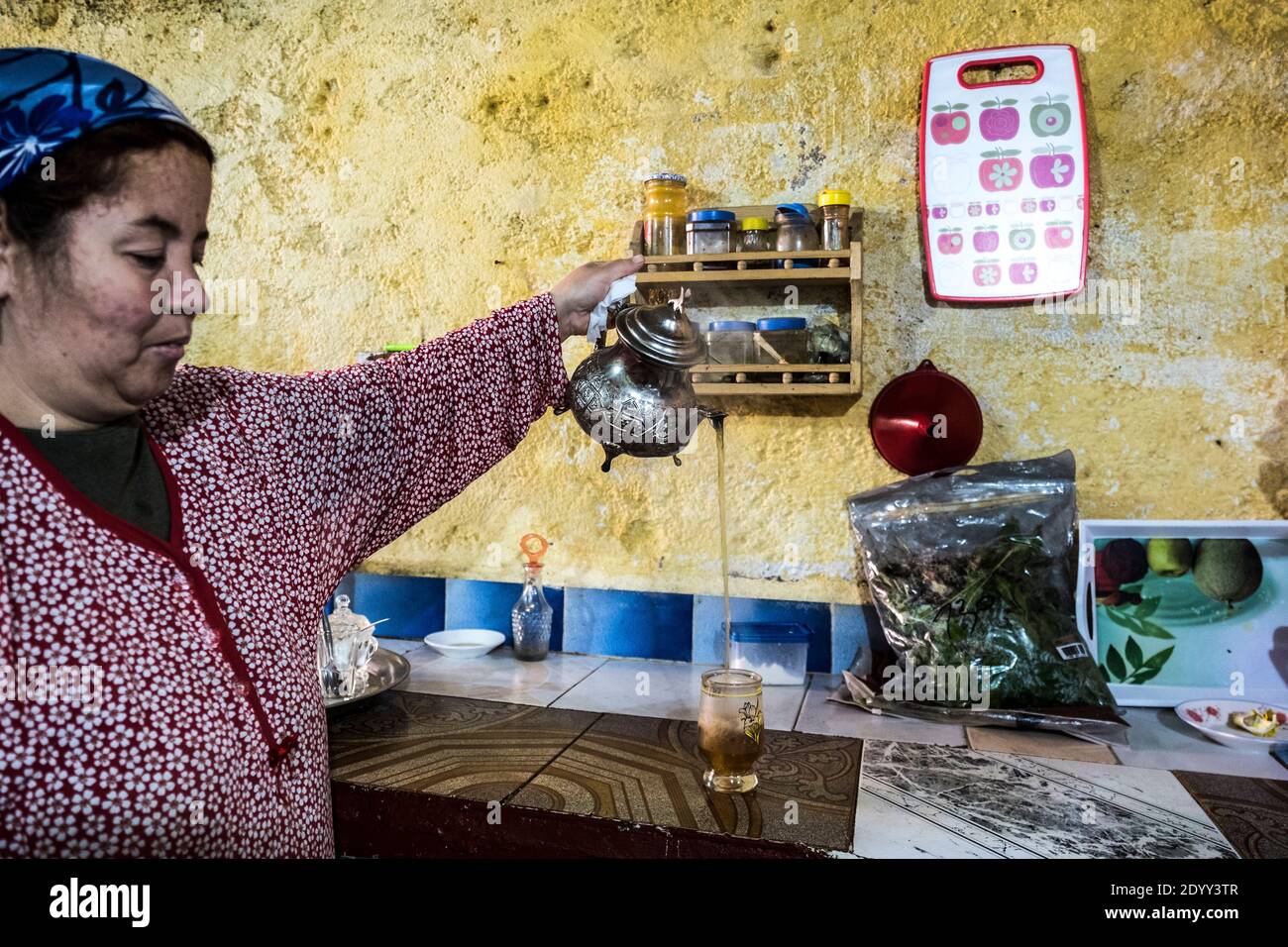 A berber woman is preparing a berber tea, in her traditional home ...