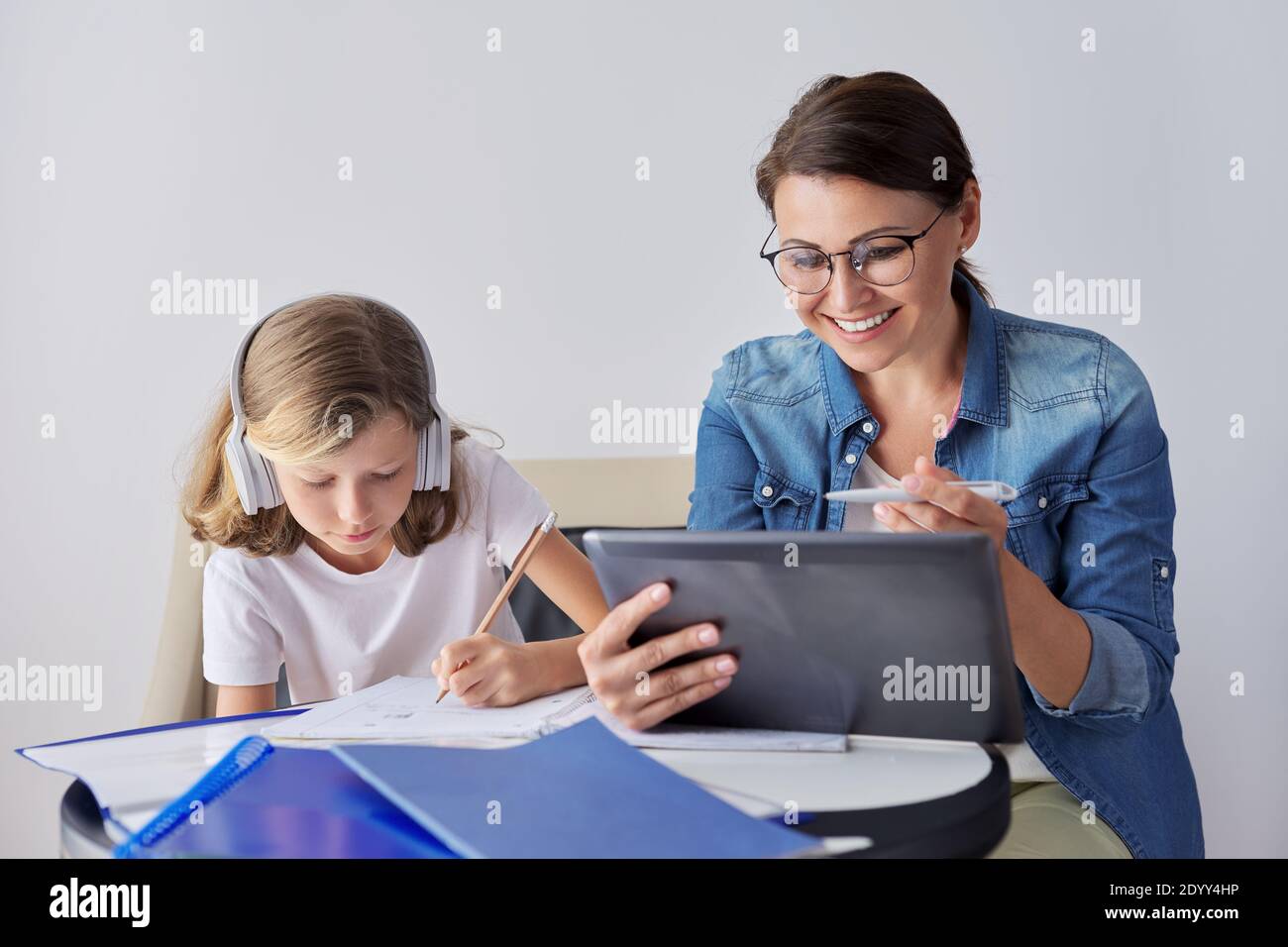 Mom and daughter student learning school lessons together at home Stock ...