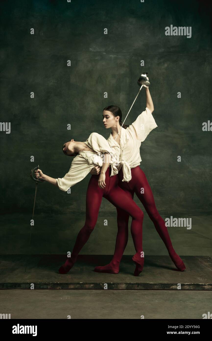 Death. Two young female ballet dancers like duelists with swords on ...
