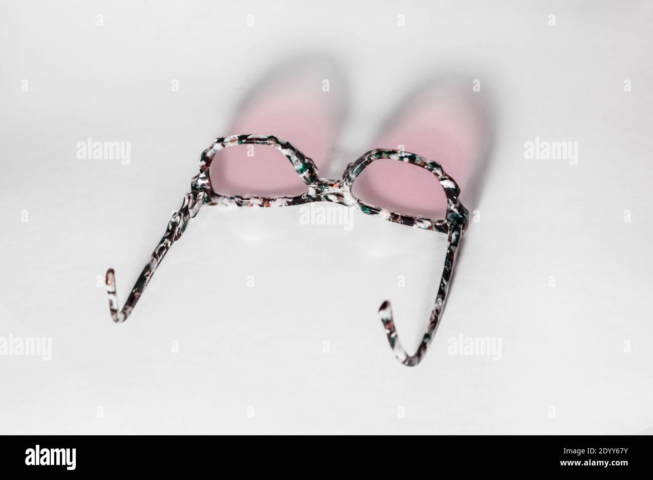 A pair of rose-colored glasses and their reflection Stock Photo - Alamy
