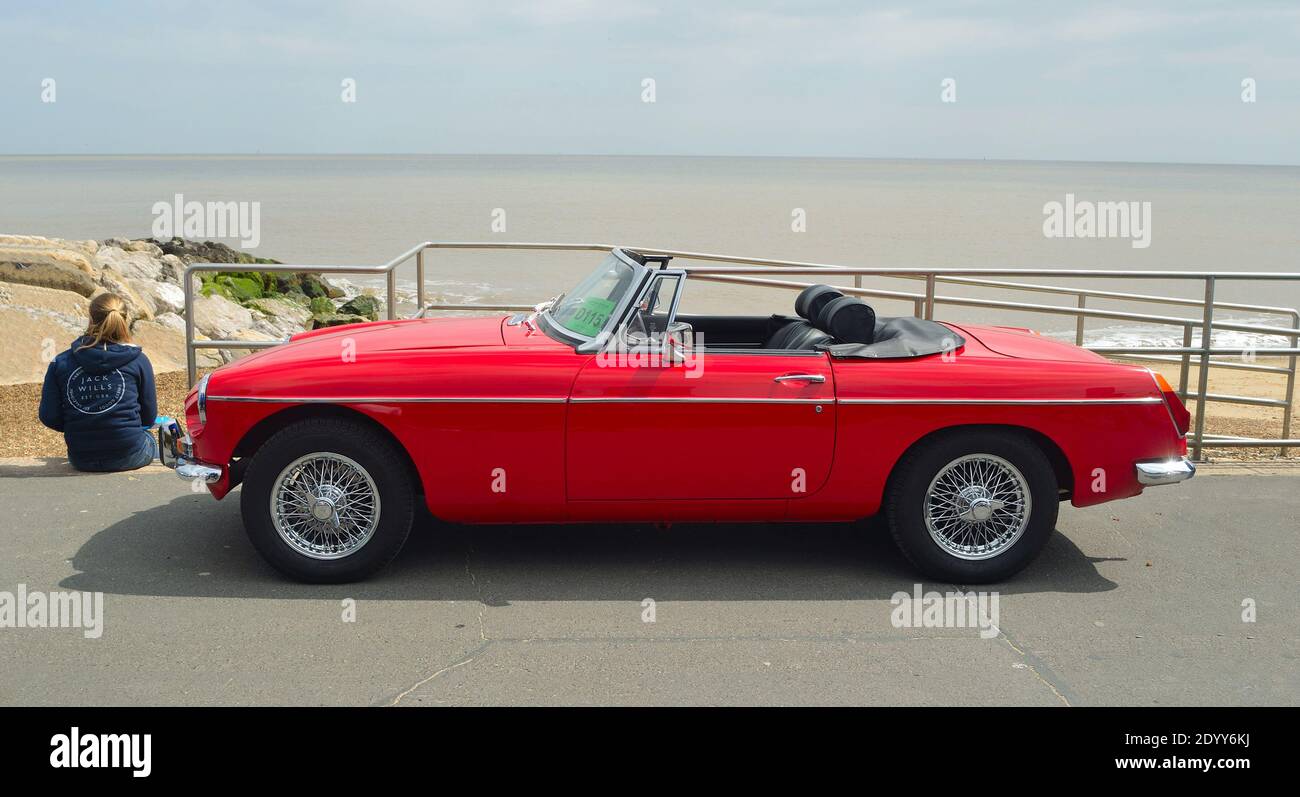 Classic Red MG Roadster Car parked on seafront promenade with sea in ...