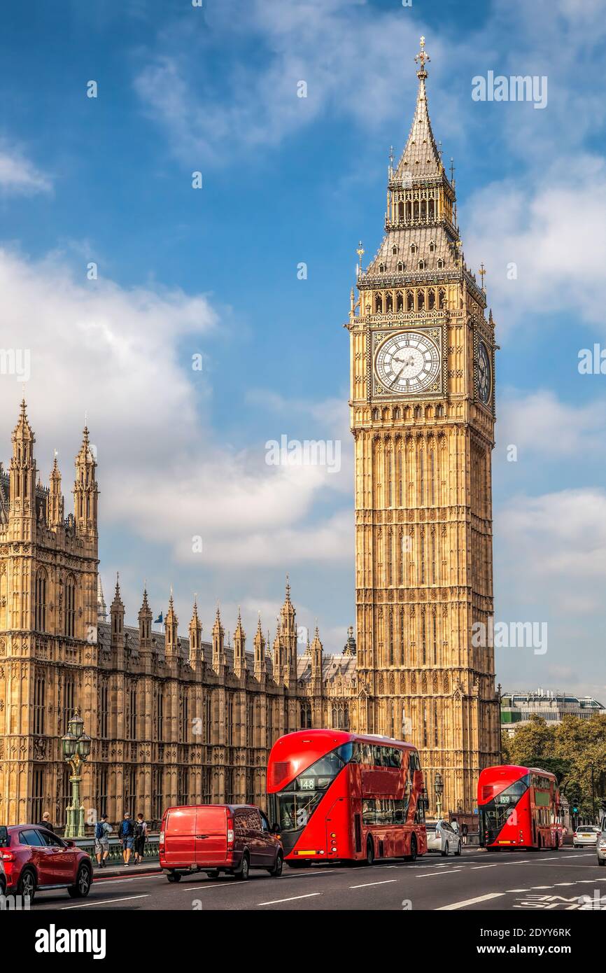Big Ben with red buses on the bridge during sunny day in London ...