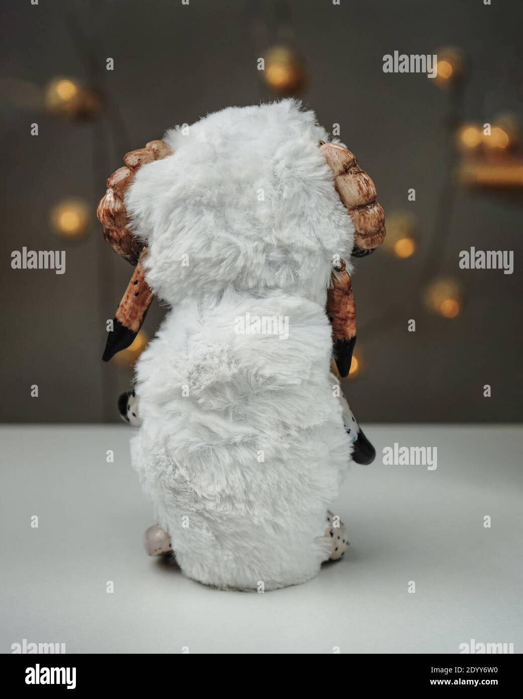 Handmade toy sad Sheep made of polymer clay on a blurred background ...