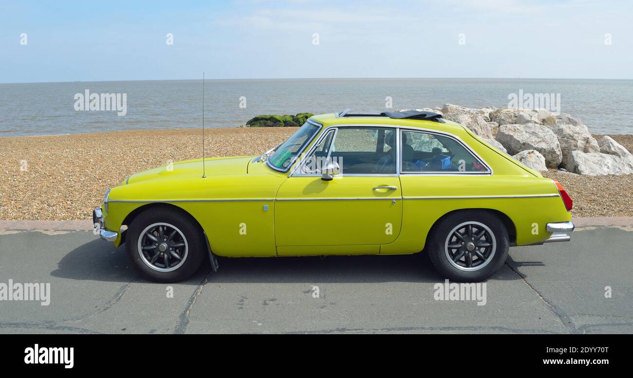 Classic Yellow MGB GT parked on seafront promenade Stock Photo - Alamy