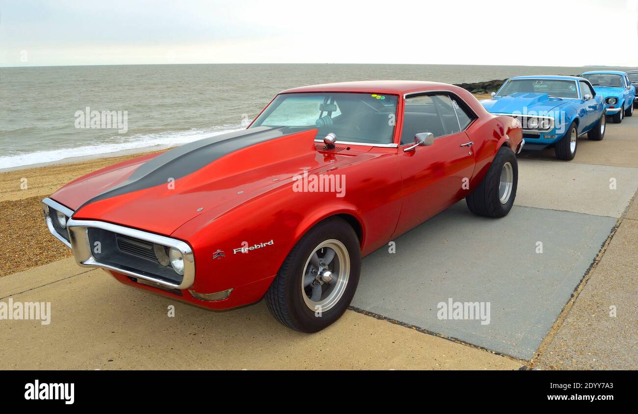 Classic Red Pontiac Firebird motor car parked on seafront promenade ...