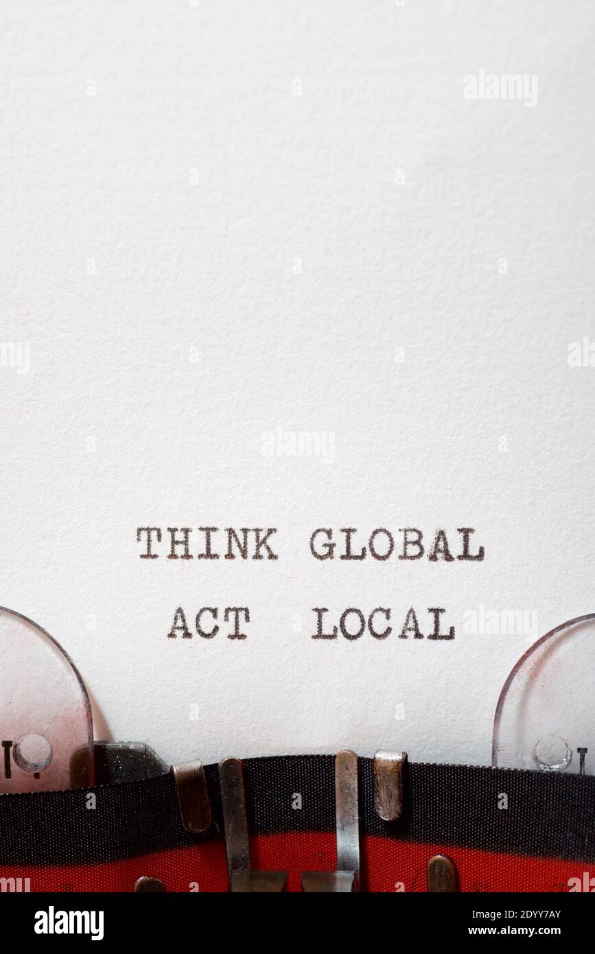 Think global act local phrase written with a typewriter Stock Photo - Alamy